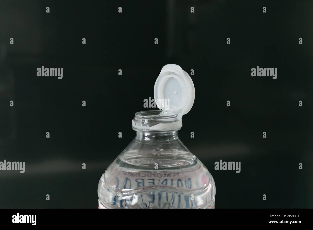 Plastic bottle with attached cap. Bottled water in a disposable ...