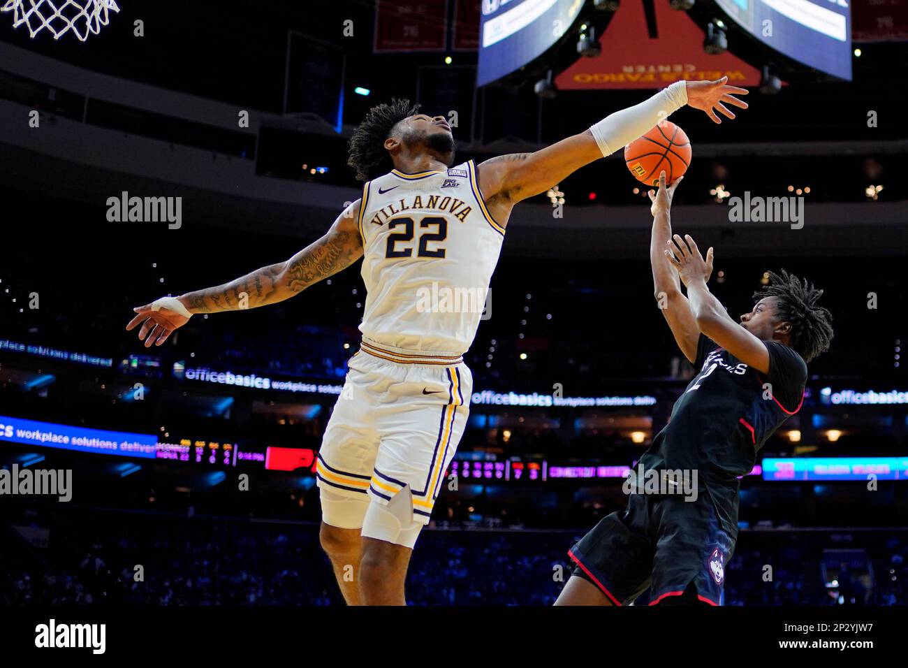 UConn's Tristen Newton, right, goes up for a shot against Villanova's ...