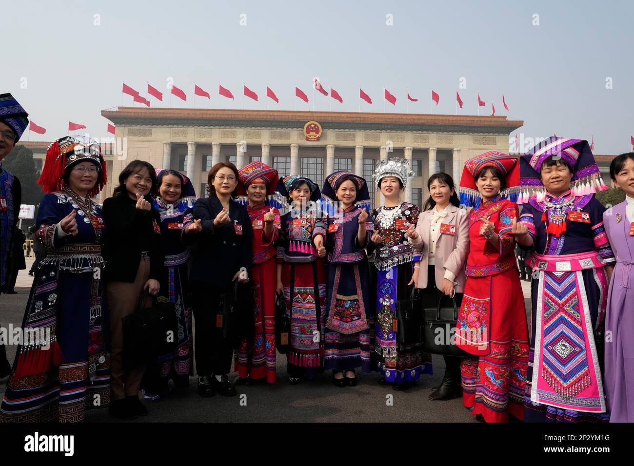 Delegates in ethnic minority dress pose for a photo after the opening ...