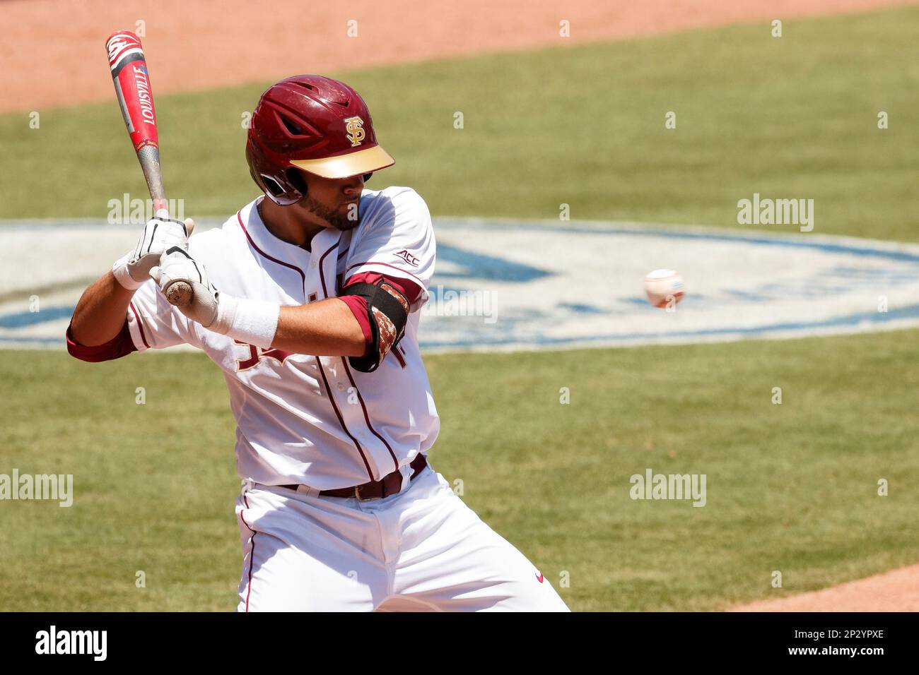 infielder John Sansone (12) of the Florida State Seminoles takes this ...