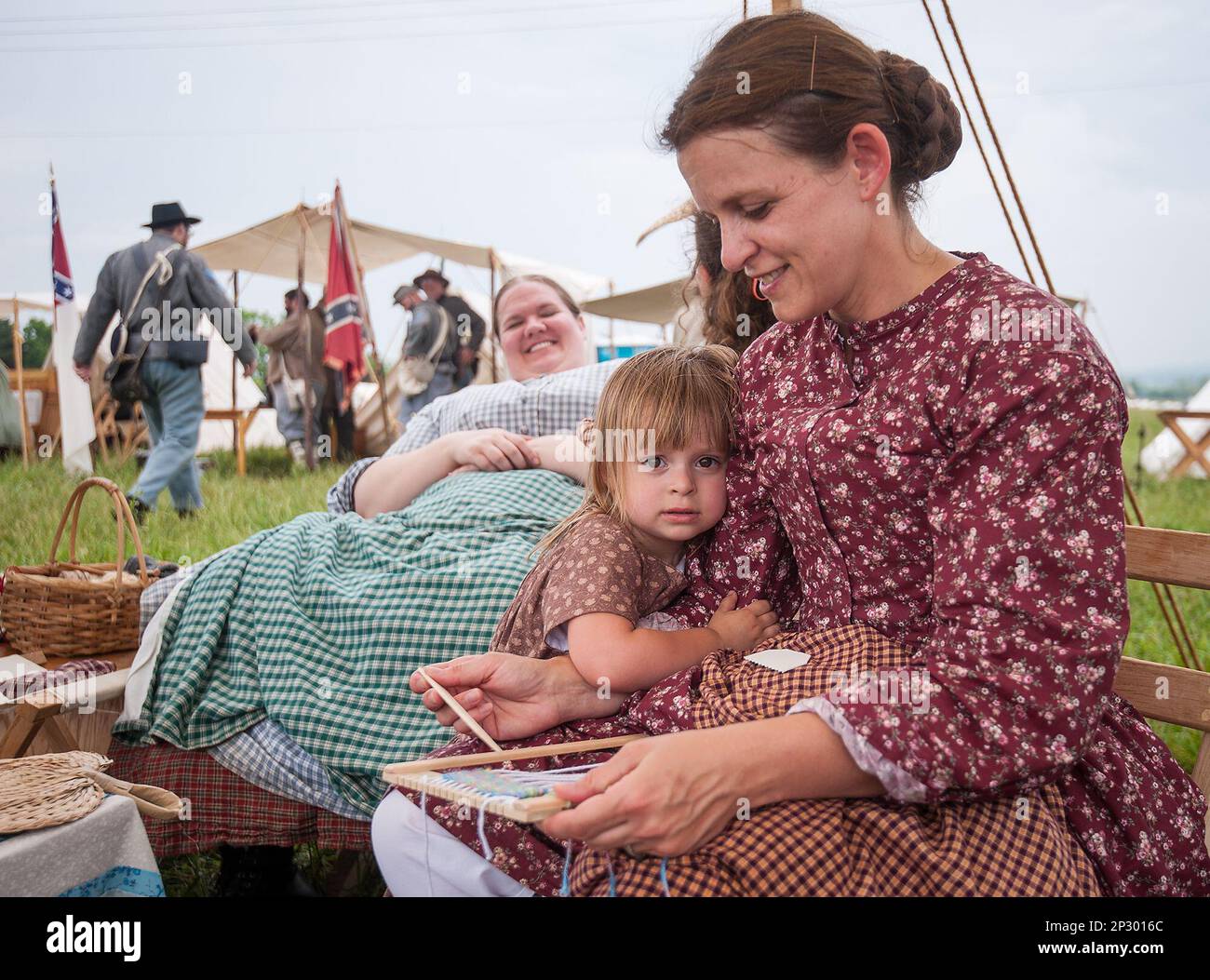 In this Sunday, May 17, 2015 photo, Mattie Allen, center, holds on has ...
