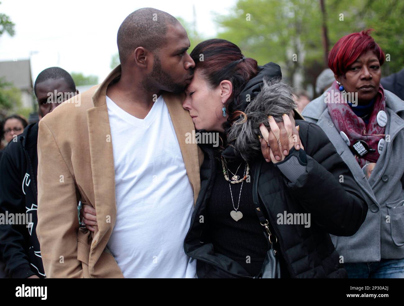 Jeff Jackson, left, comforts his girlfriend, Andrea Irwin, the mother ...