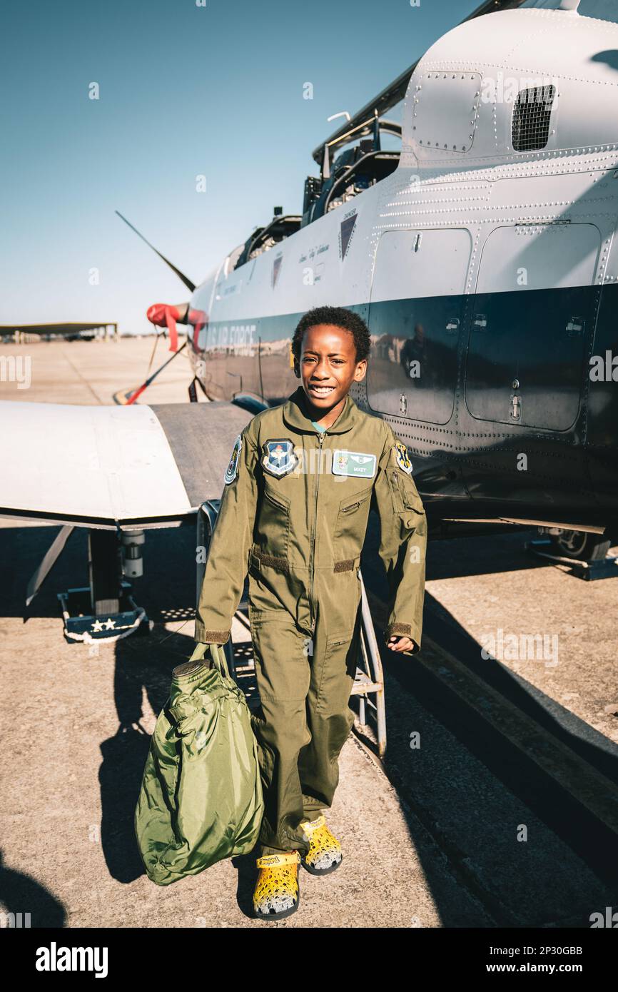Michael Deigh descends stairs near the wing of a T-6 Texan II after ...