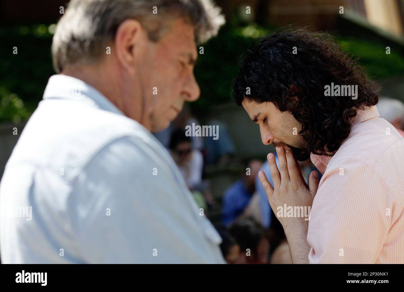 Victor Davis, left, and Rich Goodier pray during the National Day of ...