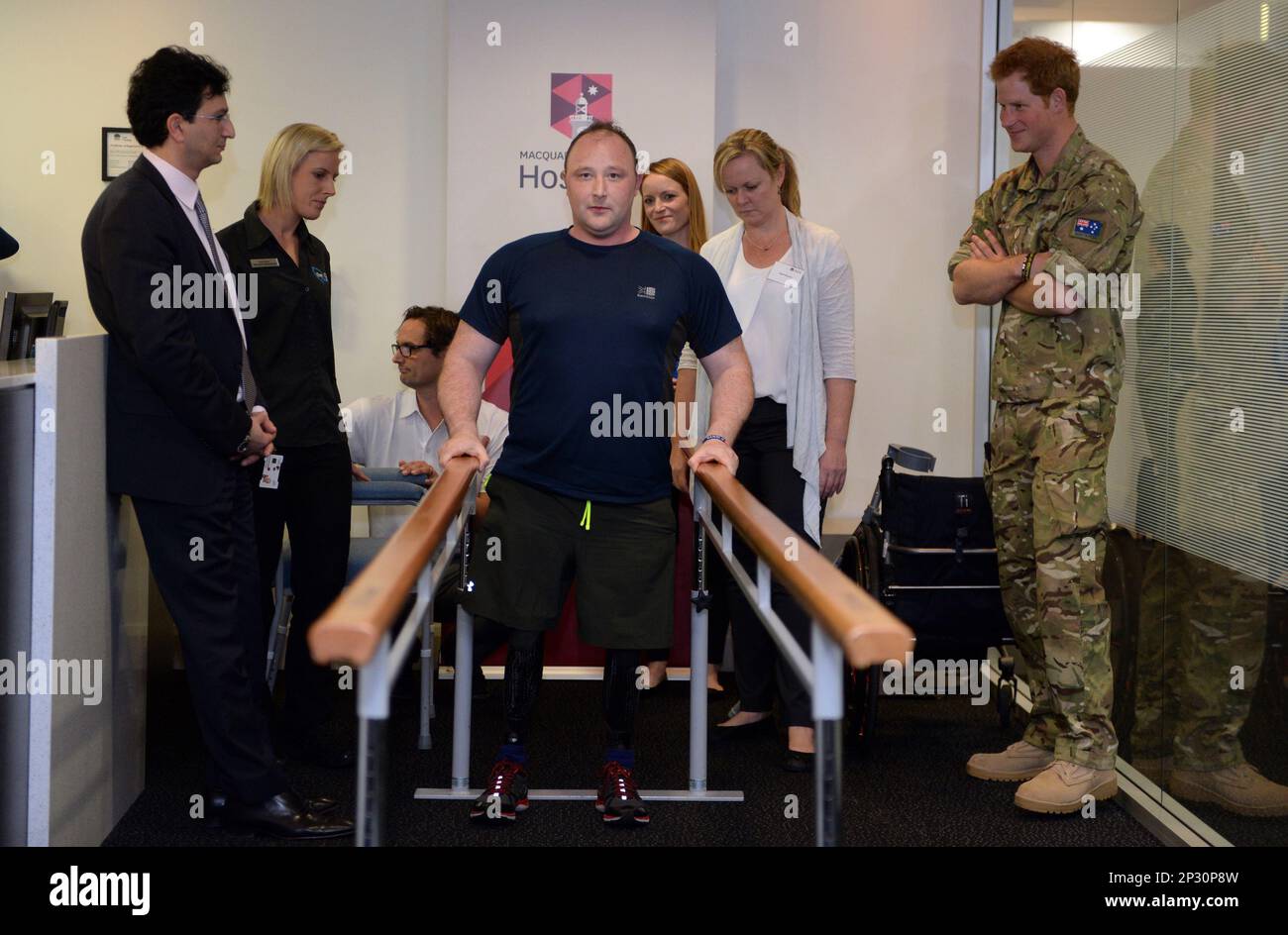Britain's Prince Harry, right, and Assoc. Prof. Munjed Al Muderis, left ...