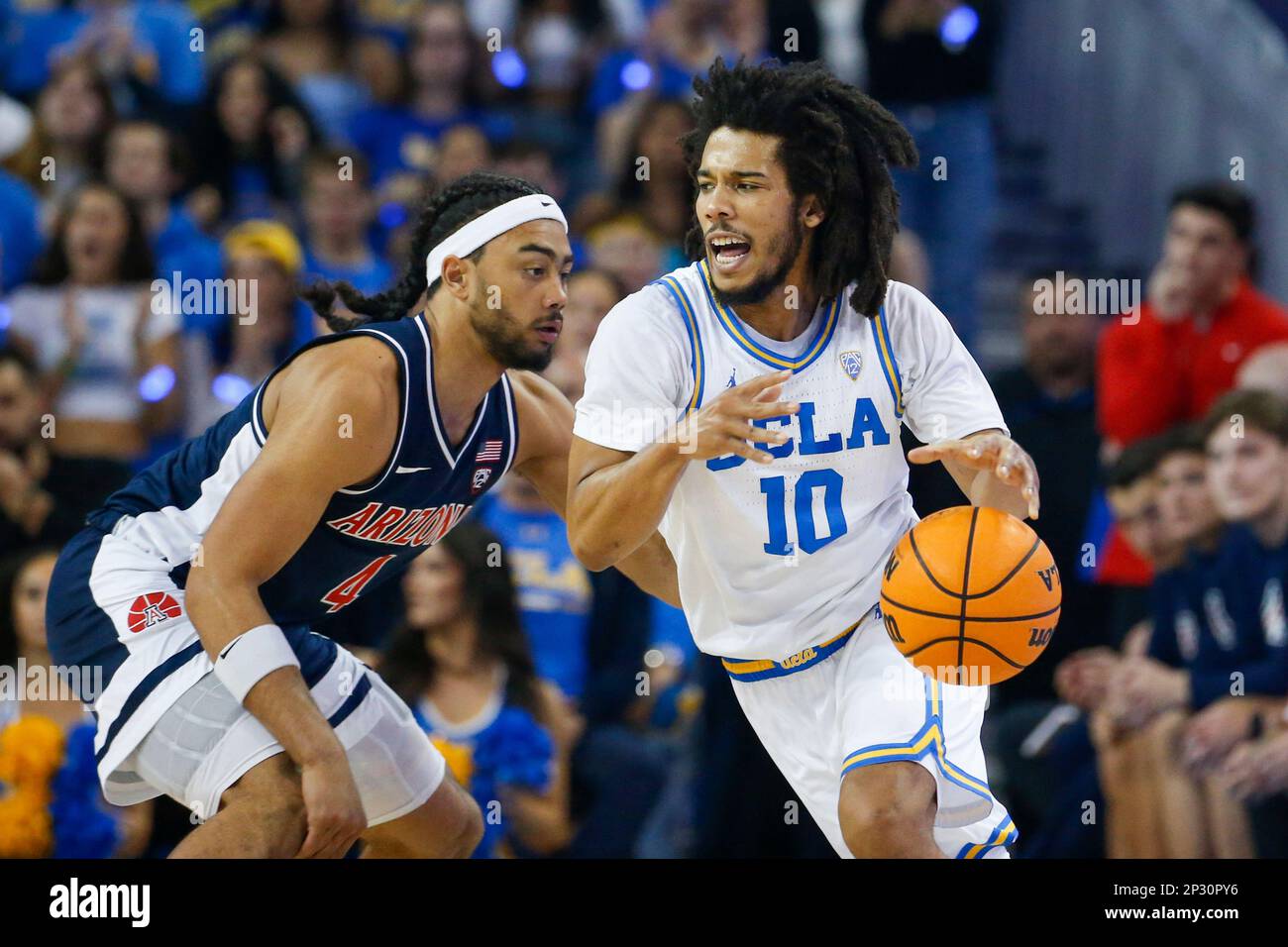 UCLA guard Tyger Campbell, right, drives past Arizona guard Kylan ...