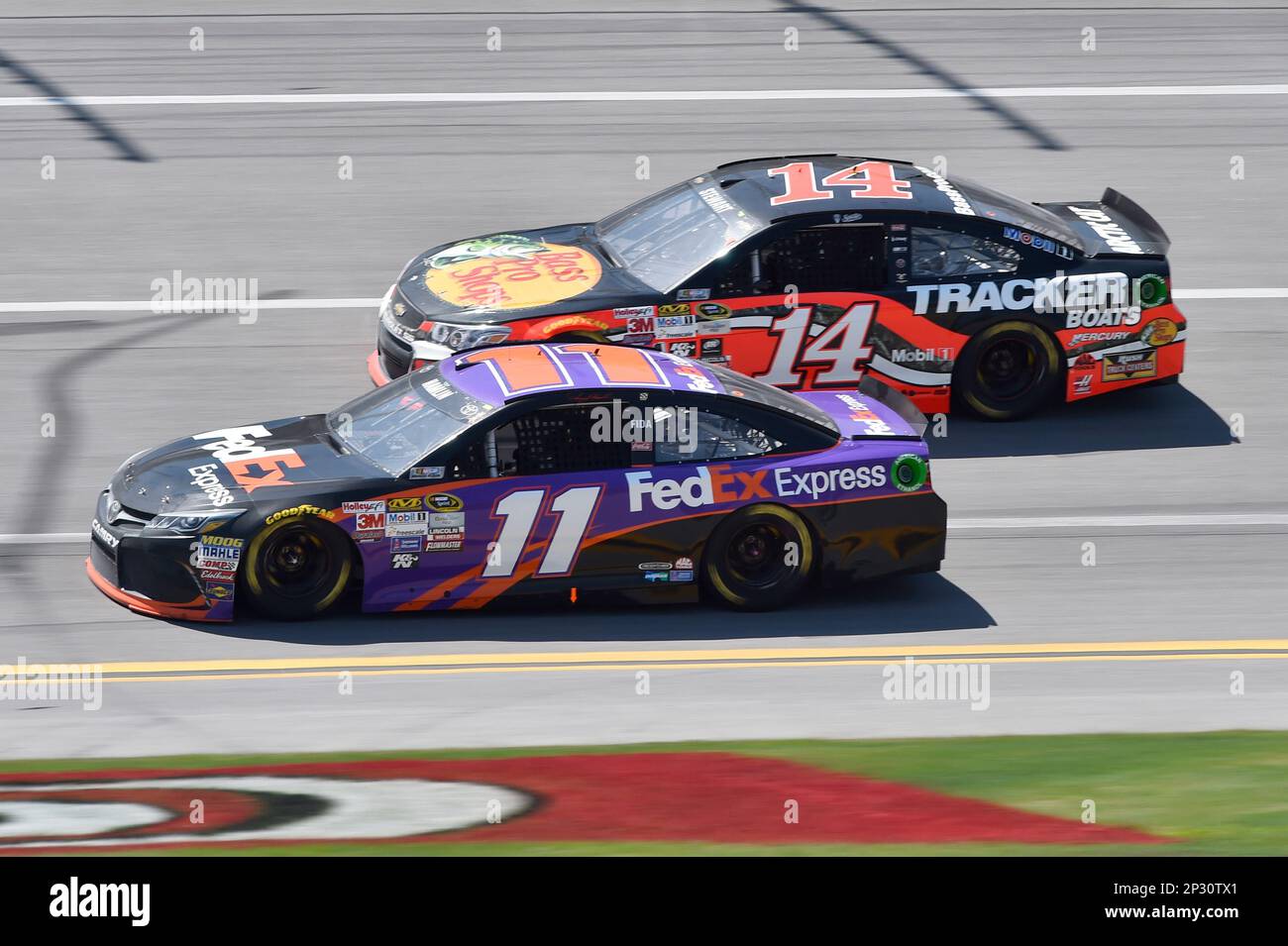 Denny Hamlin, FedEx Express Toyota Camry (11) races with Tony Stewart ...