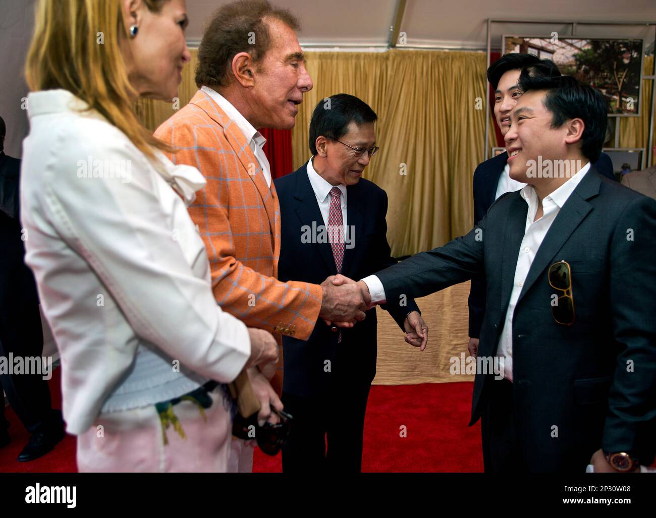 Andrea and Steve Wynn speak a few moments with Malaysia-based Genting Group CEO K.T. Lim, center ...