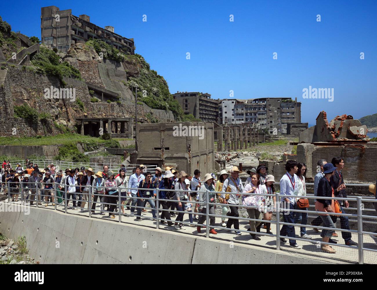 A group of tourists go on a sightseeing at Hashima Coal Mine, which is ...