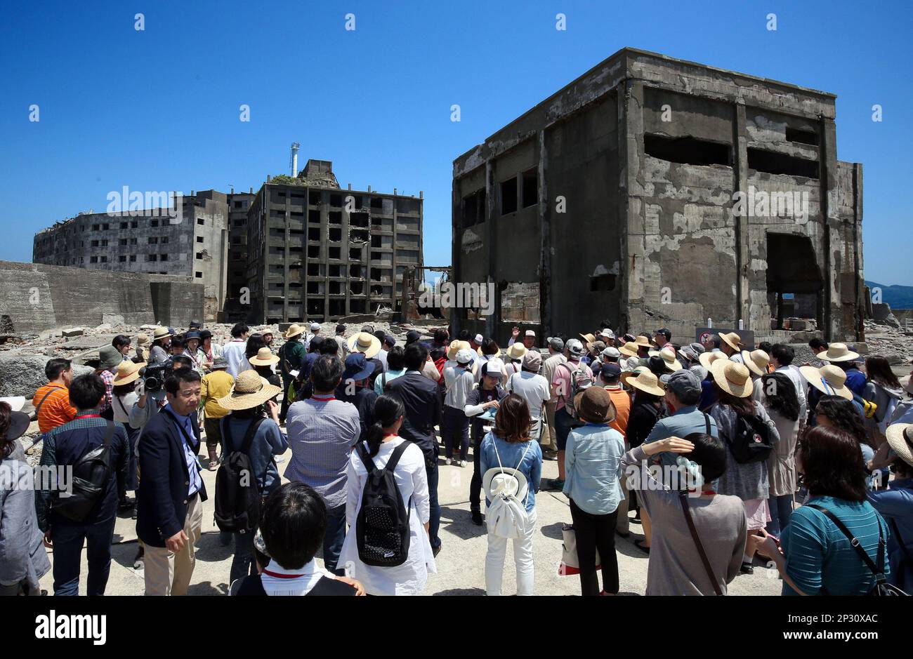 A group of tourists go on a sightseeing at Hashima Coal Mine, which is ...
