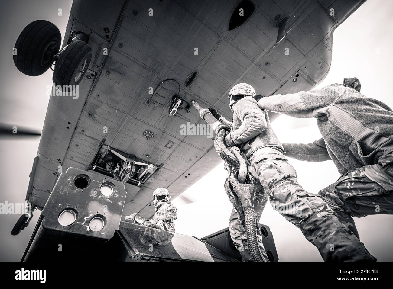 U.S. Army air defenders attach their Avenger weapon system to a Chinook ...
