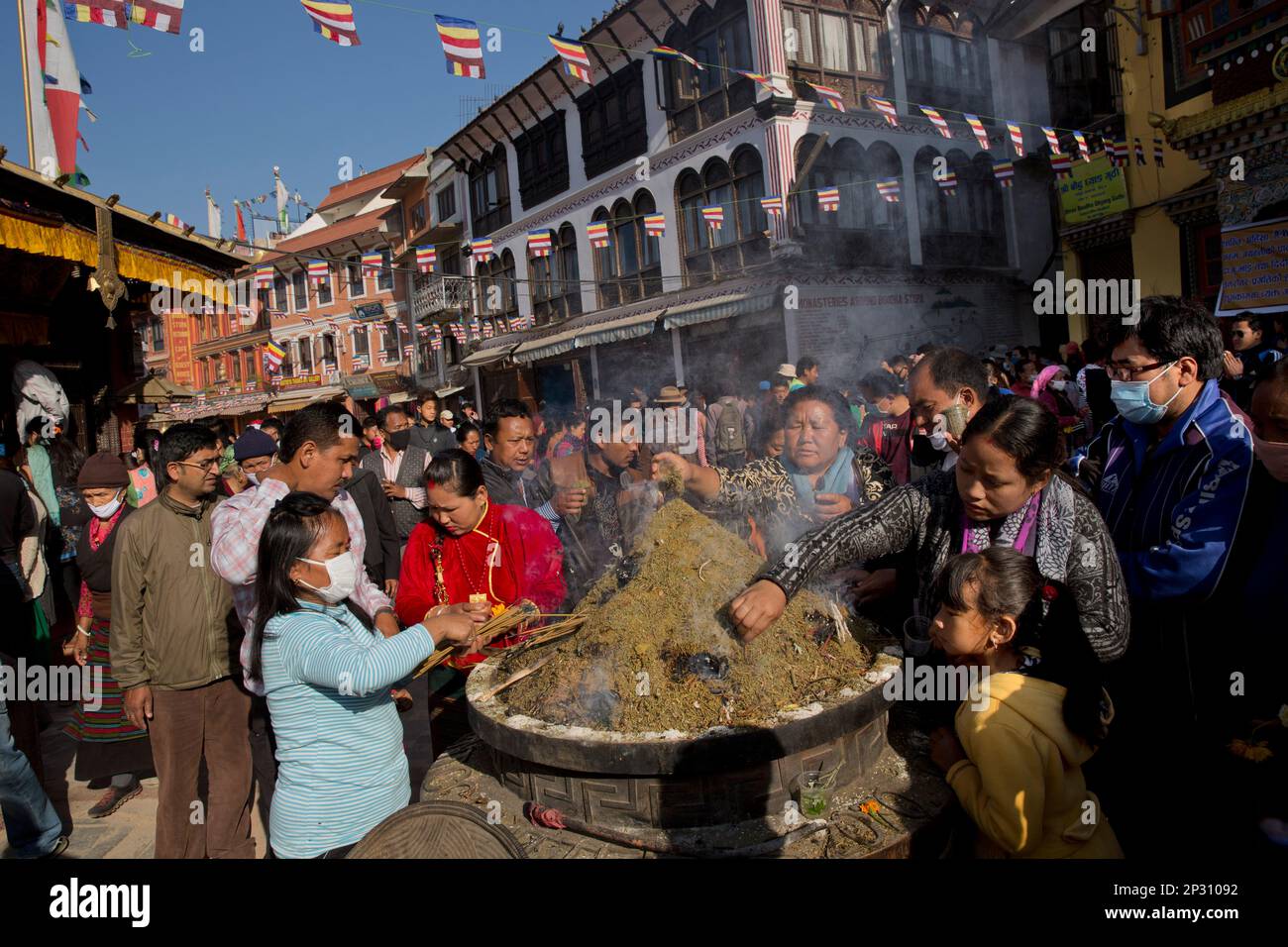 Nepalese Buddhists light incense sticks at the Boudhanath Stupa during ...
