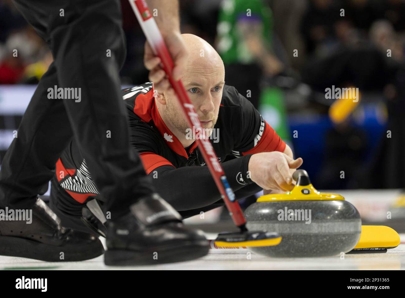 Team Ontario third, Ryan Fry makes a shot against Team Canada during ...