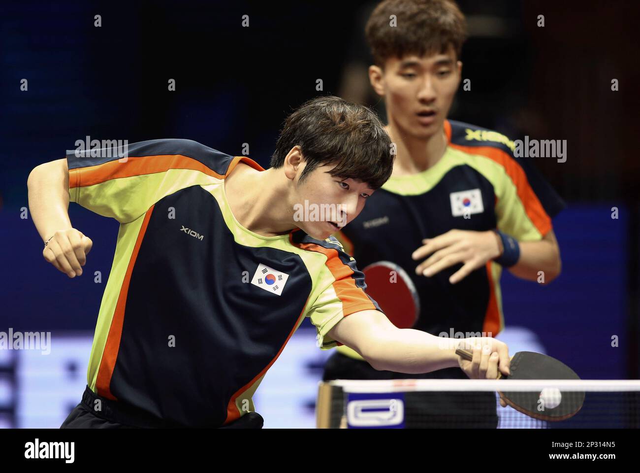 South Korea's Seo Hyundeok returns a ball as his partner Lee Sangsu, right, looks on during ...