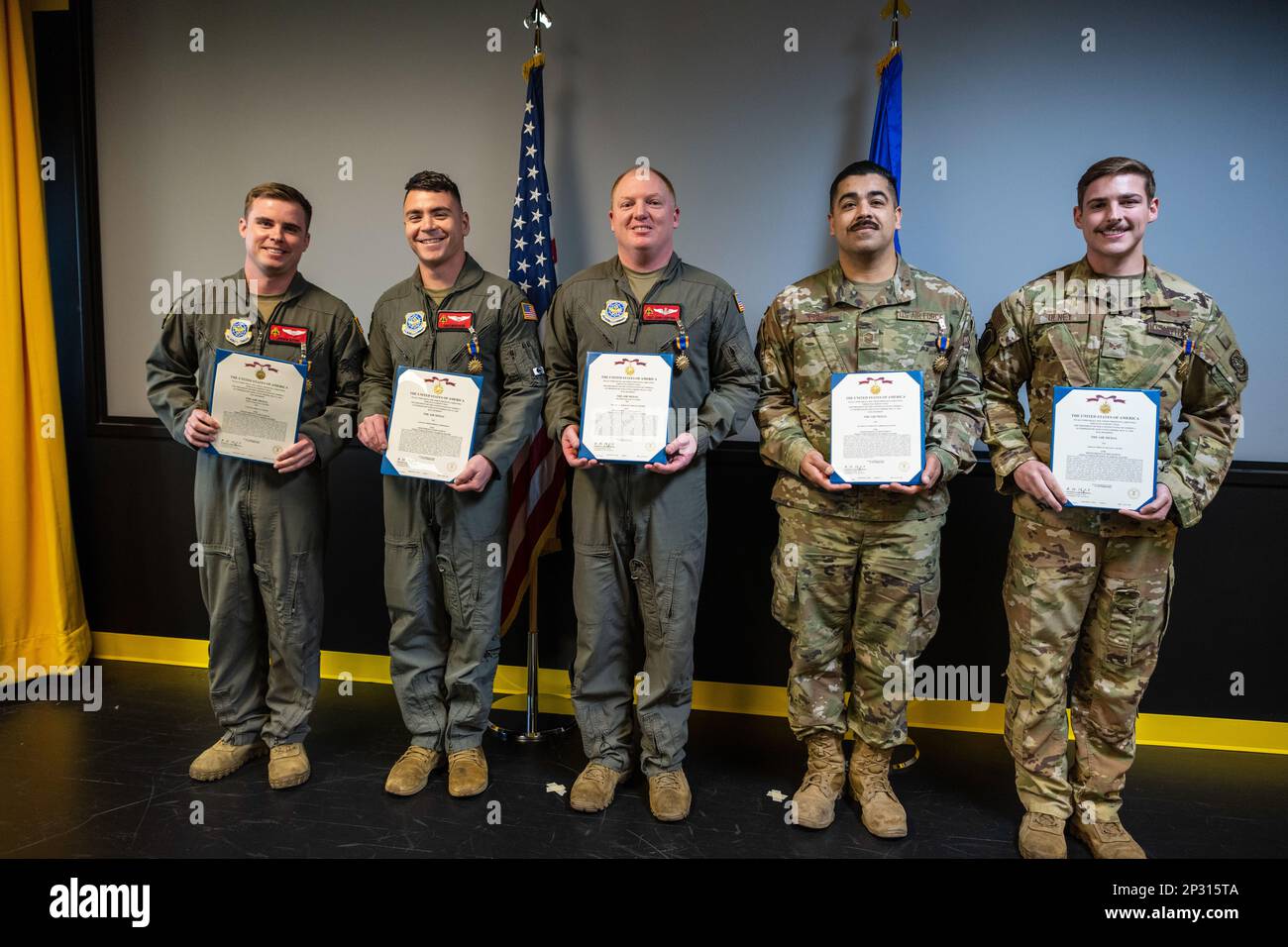 U.S. Airmen gather for a group photo holding their Air Medal citations ...