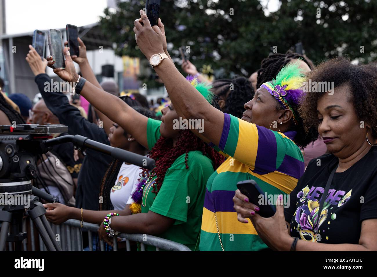 Carnival-goers take pictures with their cell phones as King Zulu and ...