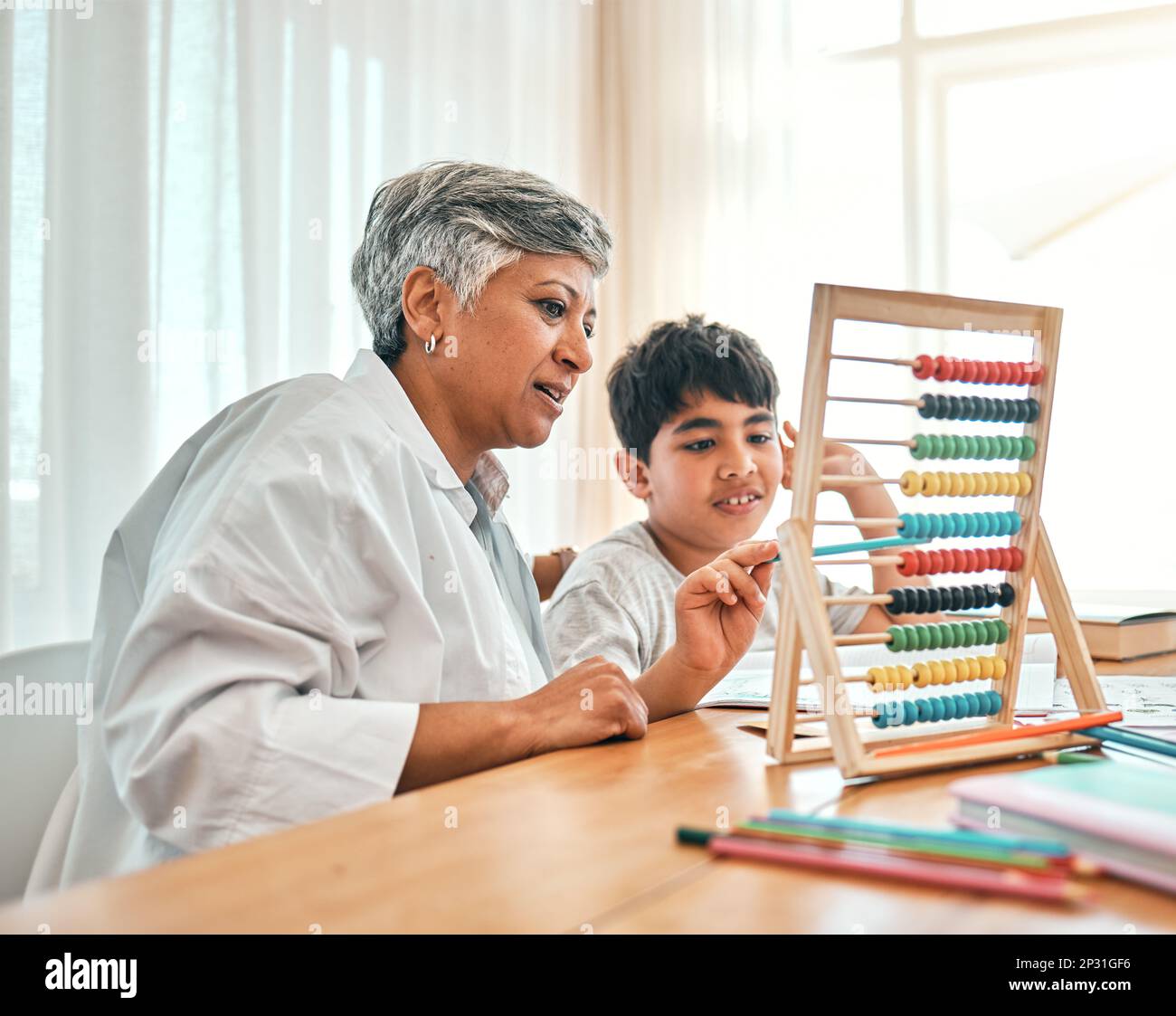 Education, autism and abacus with a grandmother teaching maths to her ...