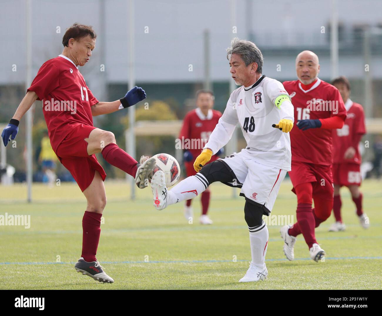 Players over 60 years old struggle to hold a ball during Osaka Senior ...