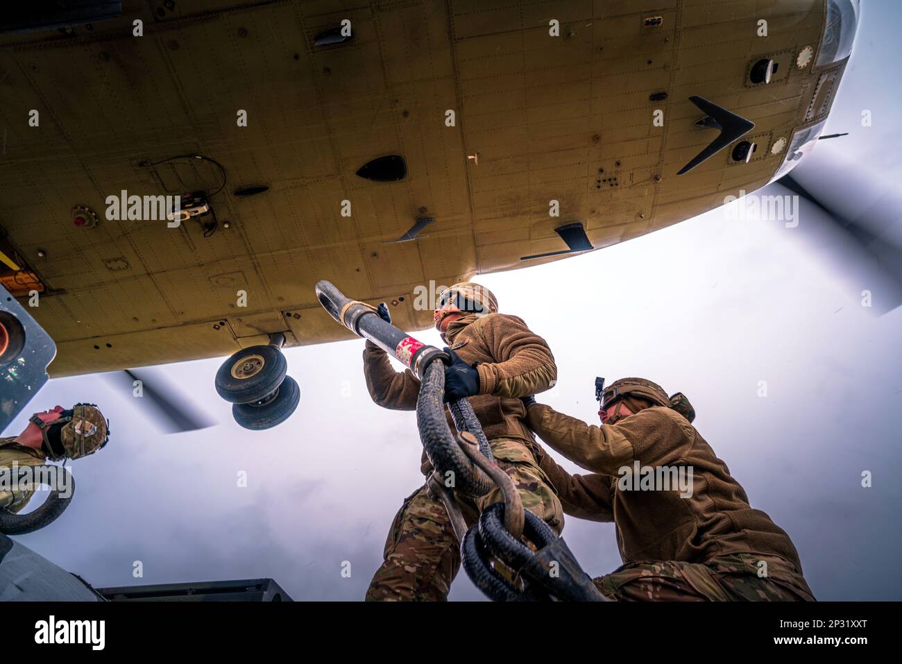 U.S. Army air defenders attach their Avenger weapon system to a Chinook ...