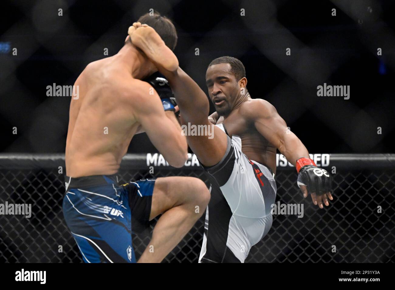 Geoff Neal, right, connects with a kick to Shavkat Rakhmonov during a ...