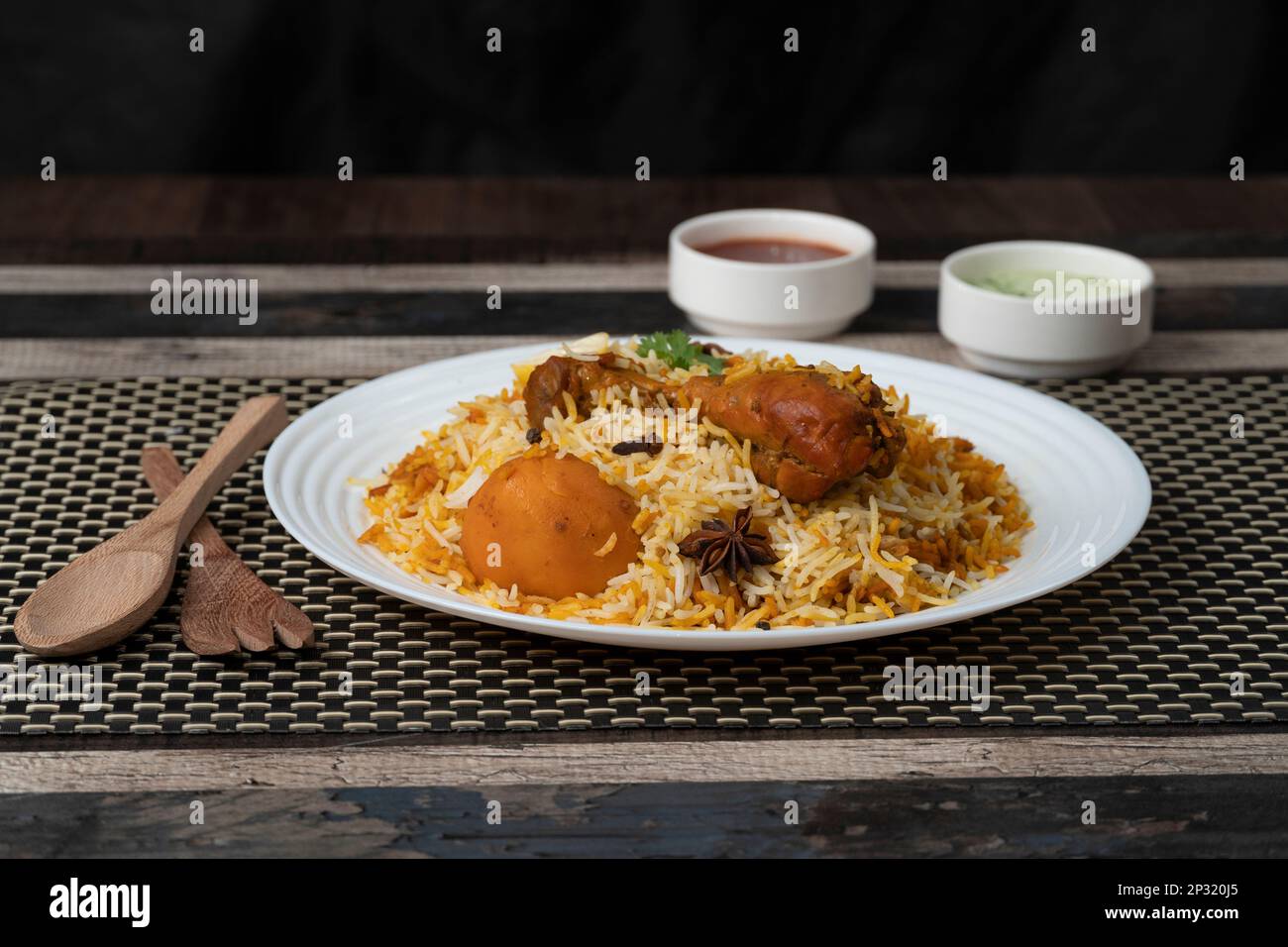 Chicken Biryani, popular Pakistani Indian food in a white plate on dark ...