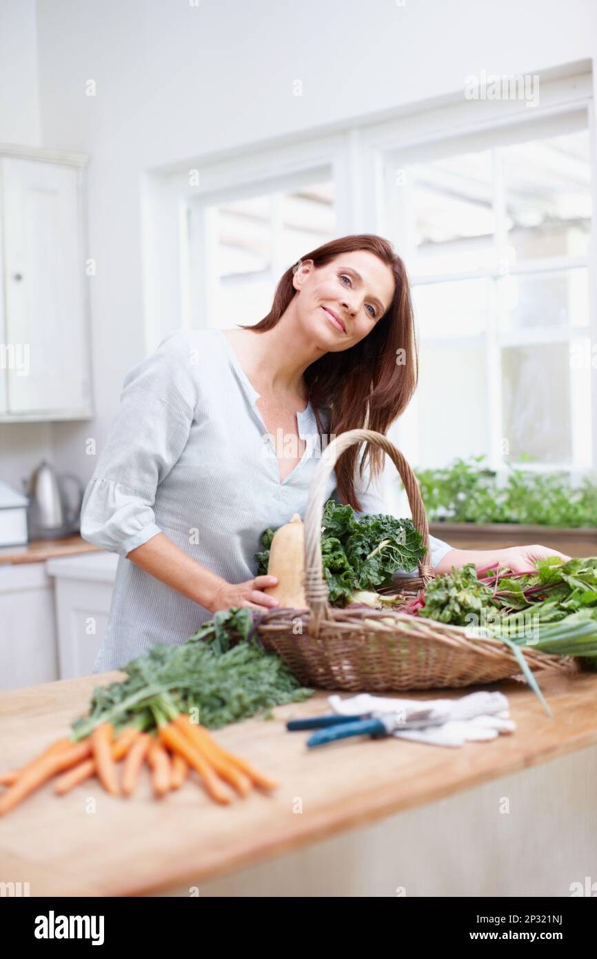 Cooking from the garden. Portrait of a beautiful woman standing behind ...