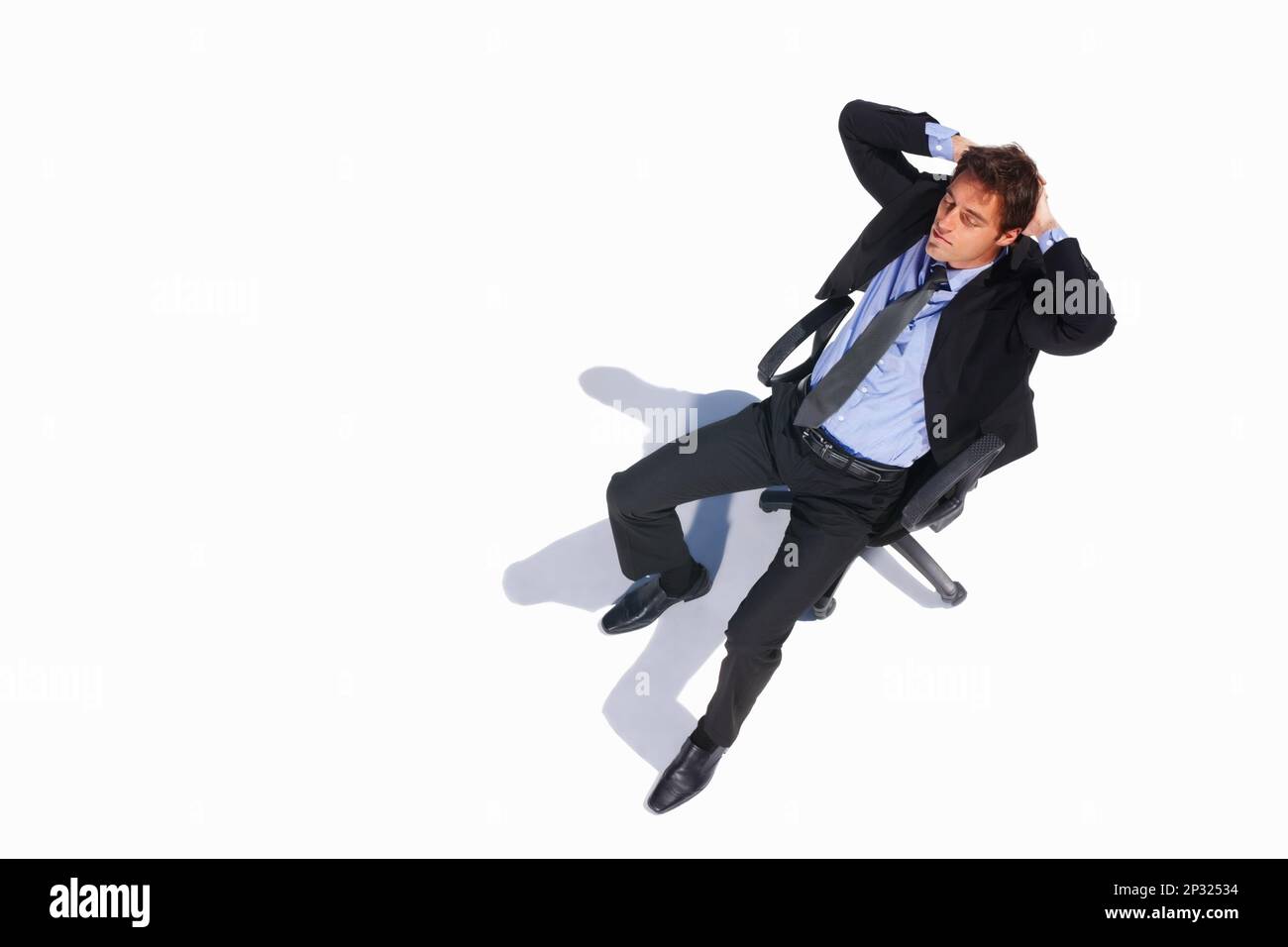 Top view of a relaxed business man sitting on a chair. Top view of a ...