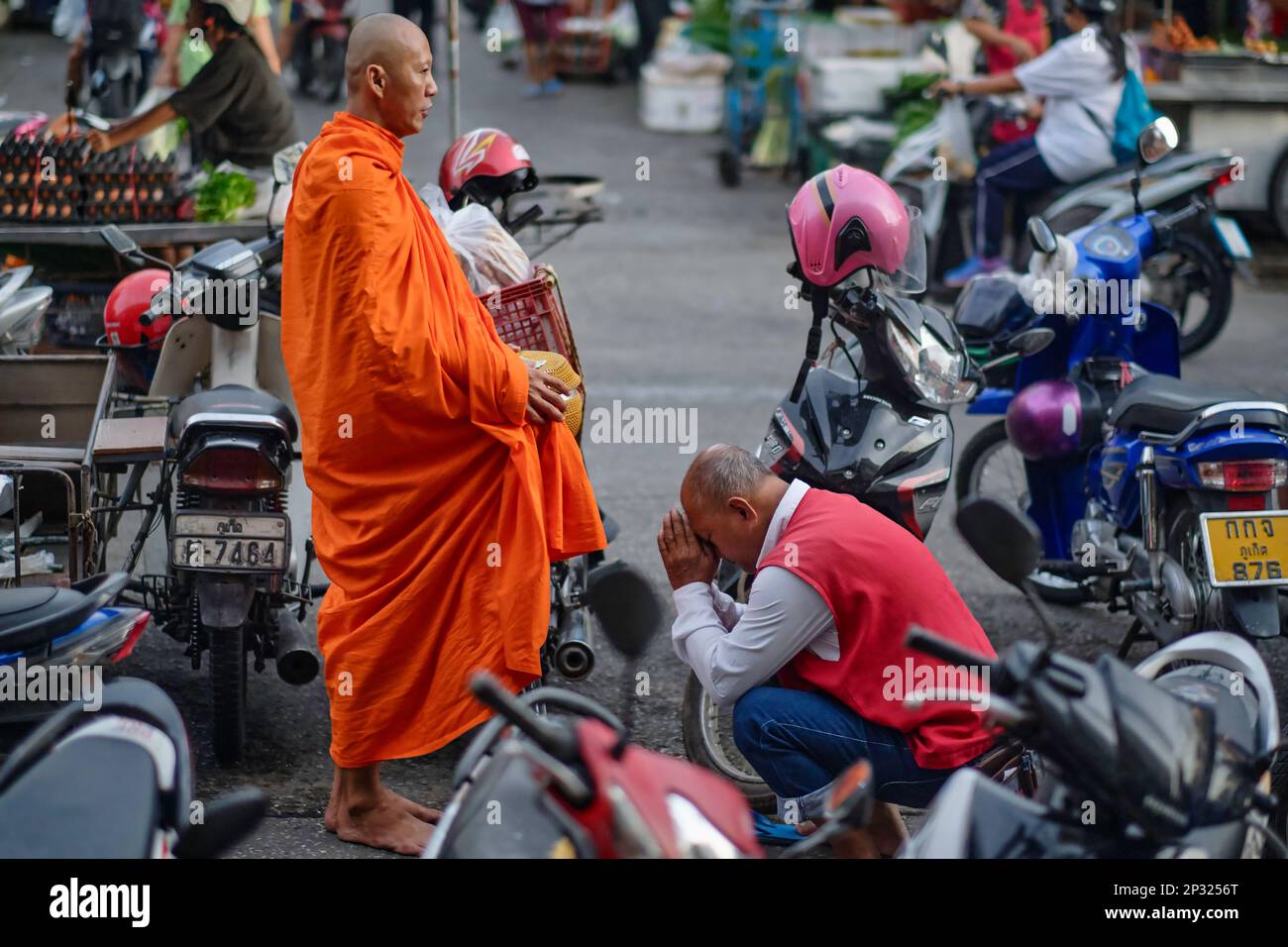 A motorcycle taxi driver in the main market in Phuket Town, Thailand ...