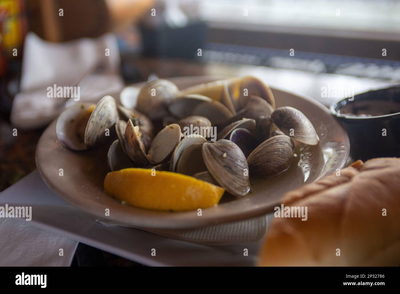 Steamed Clams with lemon with butter and bread Stock Photo - Alamy
