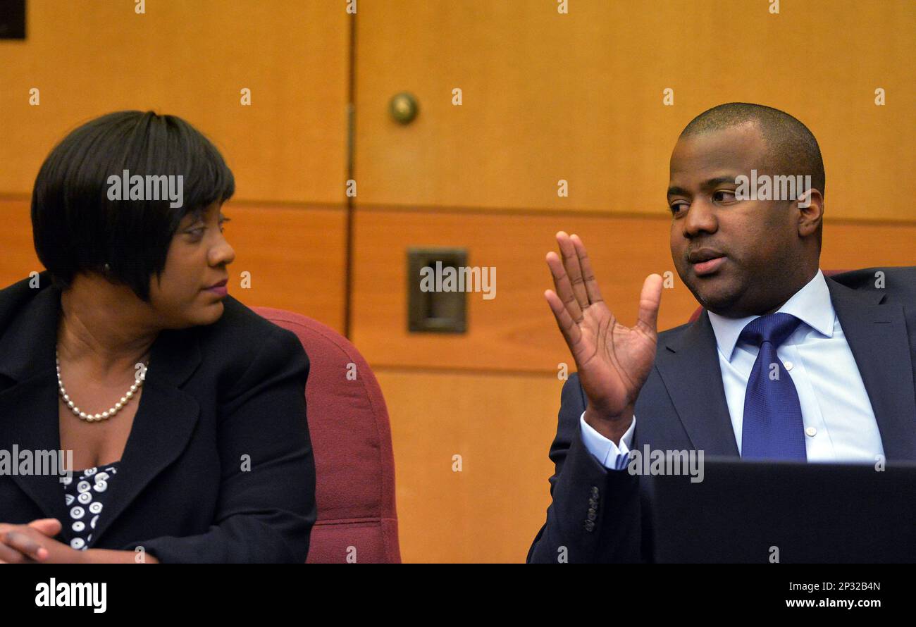 Defense attorney Benjamin Davis talks with his client, former APS SRT ...