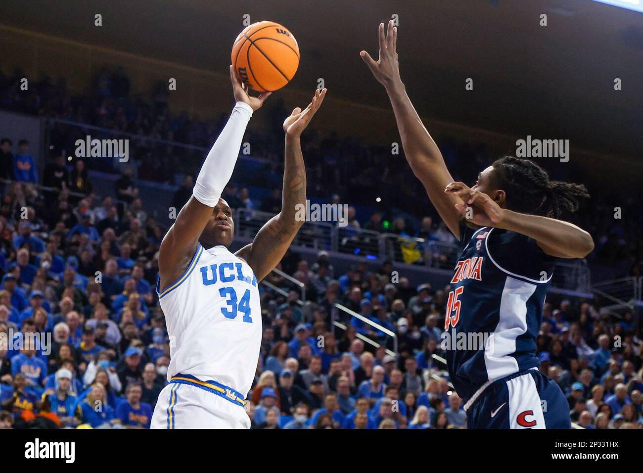 UCLA guard David Singleton, left, shoots against Arizona guard Cedric ...