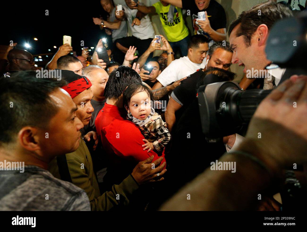 Boxer Manny Pacquiao, of the Philippines, holds his youngest child ...