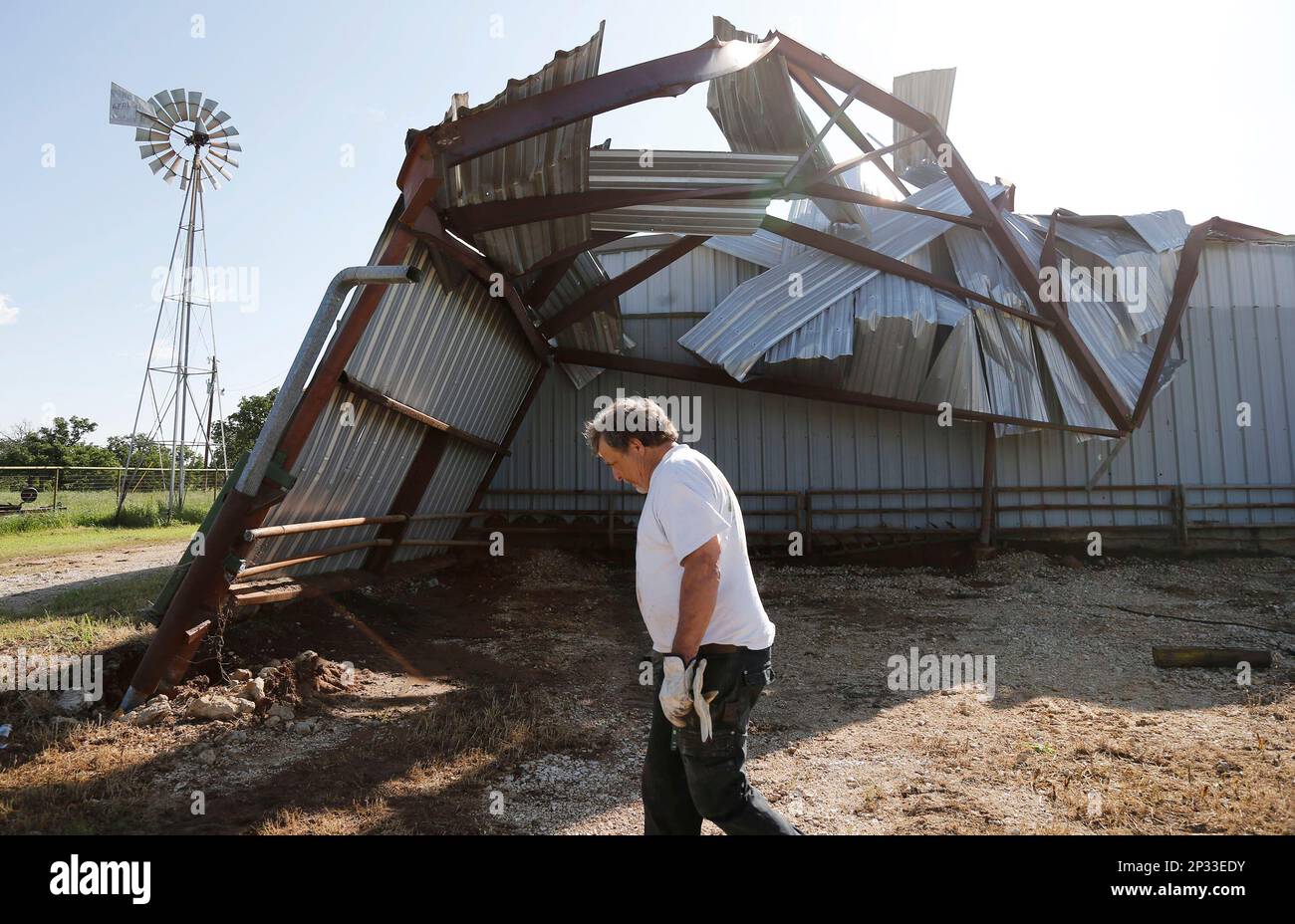 John Kuethe, owner of Green Acres Farm, surveys the damage to his barn ...