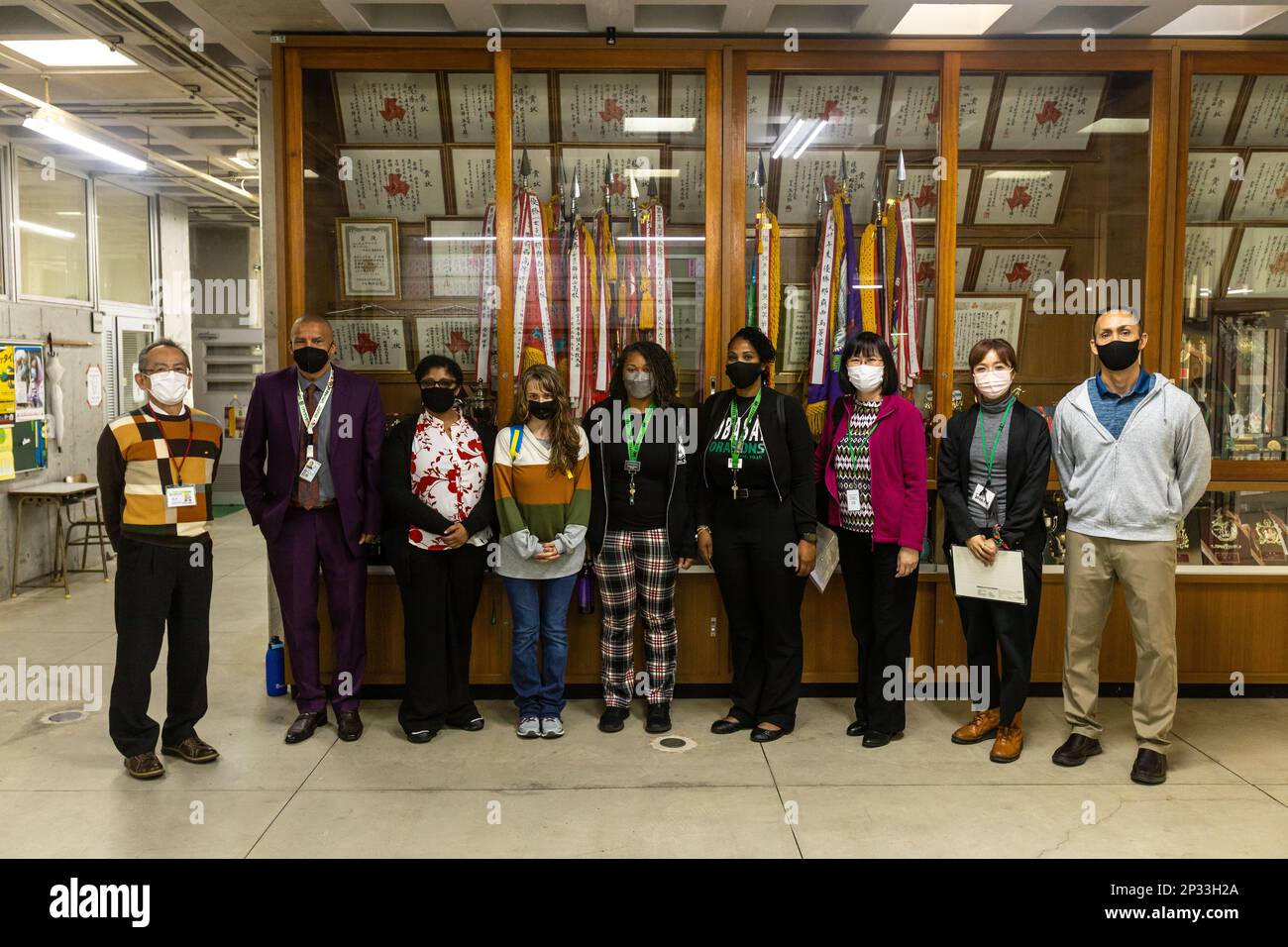 The staff of Kubasaki and Naha Nishi High Schools pose for a group ...