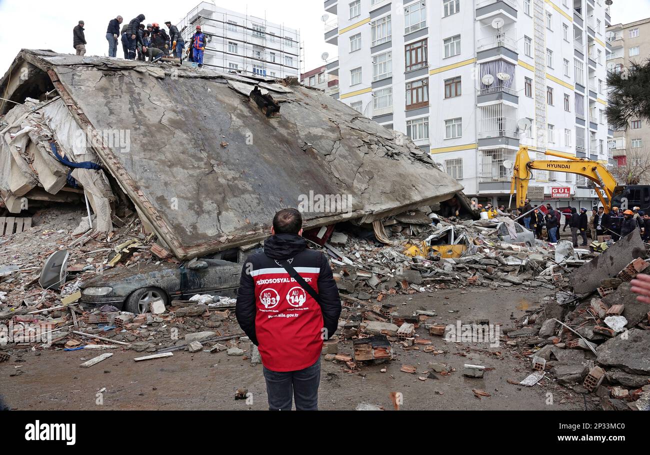 Rescue workers seen at the Misami apartment, which was destroyed during ...