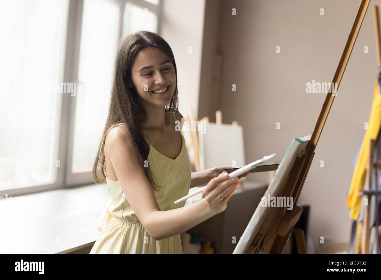 Happy inspired art school student girl enjoying creative hobby Stock ...