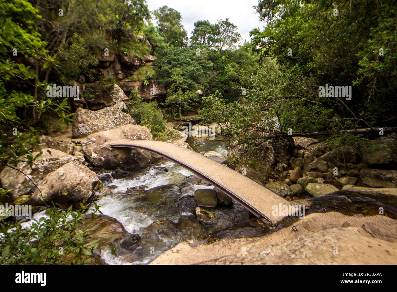 A small, bowed bridge, called the queens crossing, crossing the Mahai ...