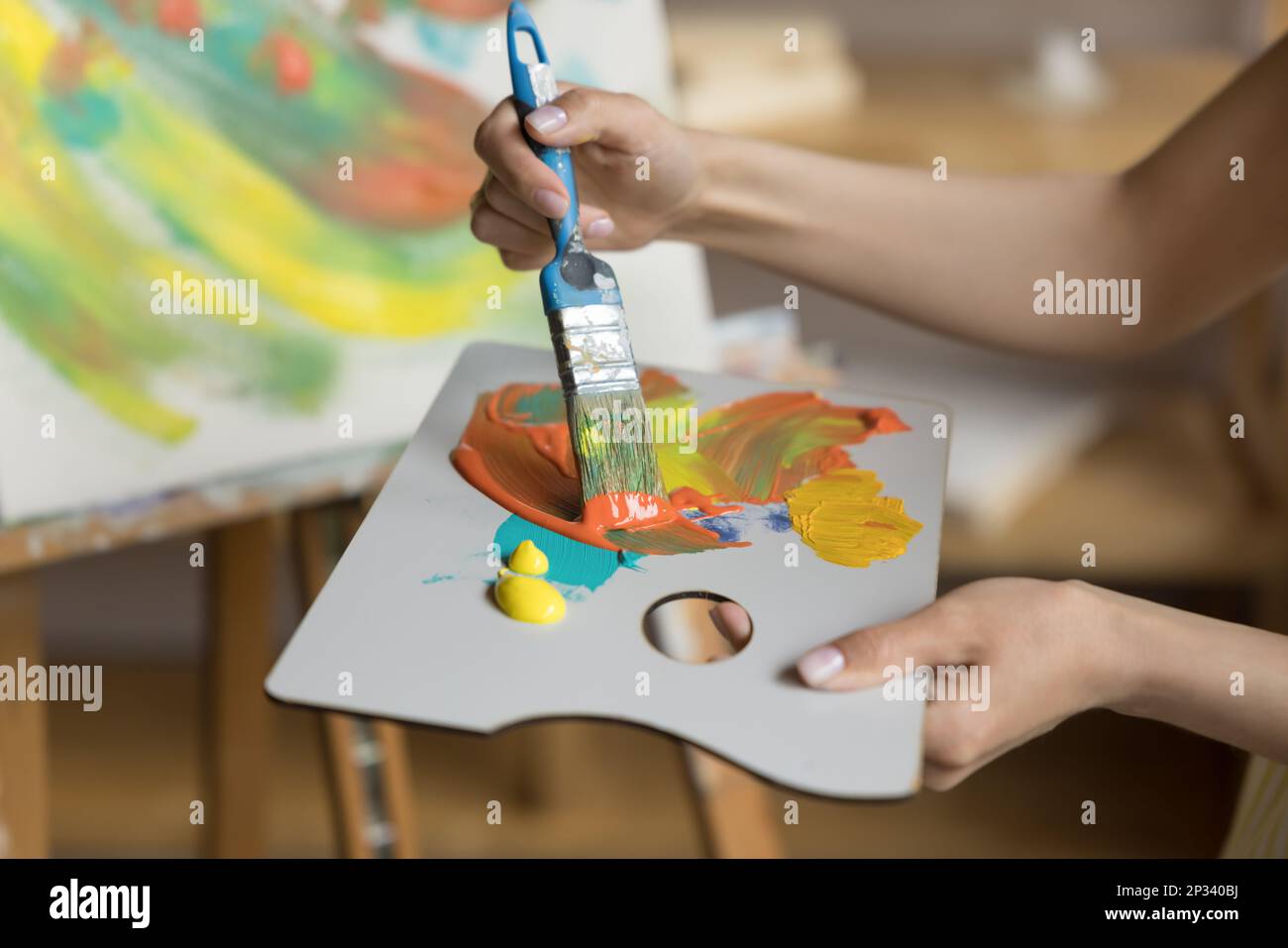 Hand of artist blending paints for drawing, mixing colors Stock Photo ...