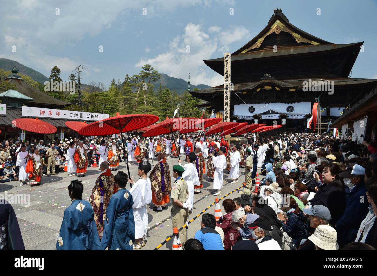 Priests advance toward the main hall of Zenkoji temple in Nagano during ...