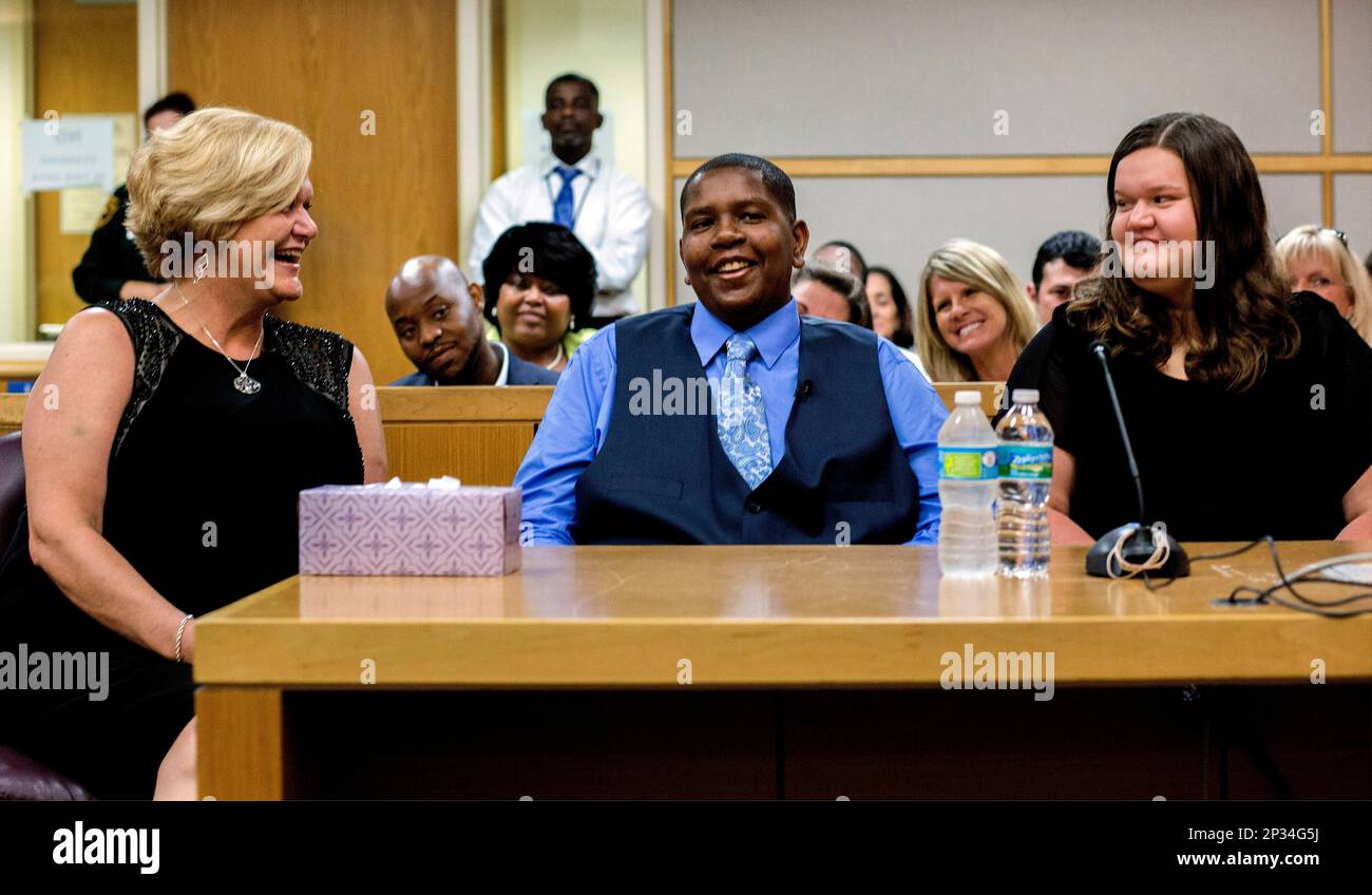 A light moment as adoption of Davion Only,17, second from left, is ...