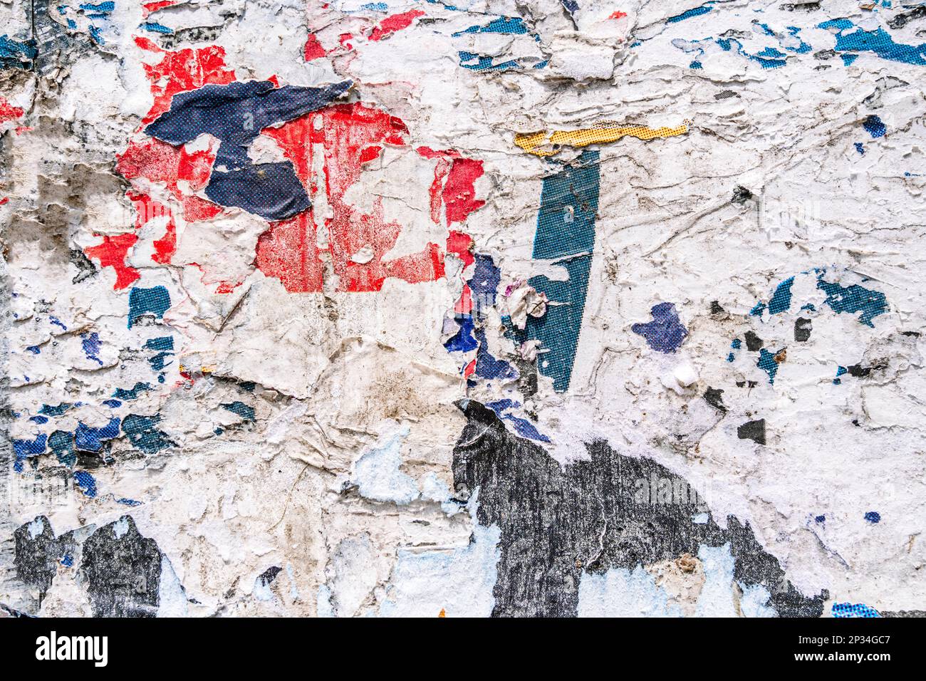 Torn paper collage background on an old poster on a street wall ...