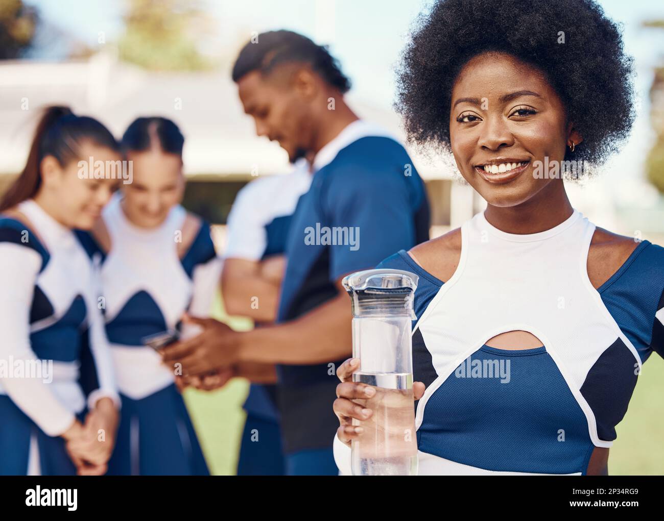 Cheerleader, portrait or black woman drinking water in cheerleading in ...