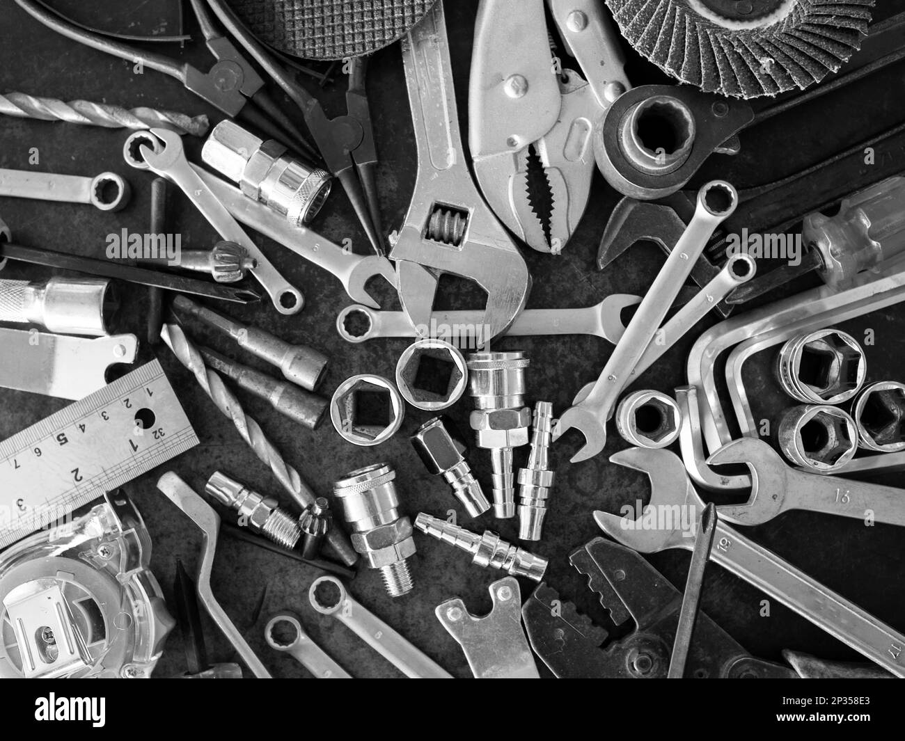 Hand tools consisting of wrenches, pliers, socket wrenches, laid out on ...