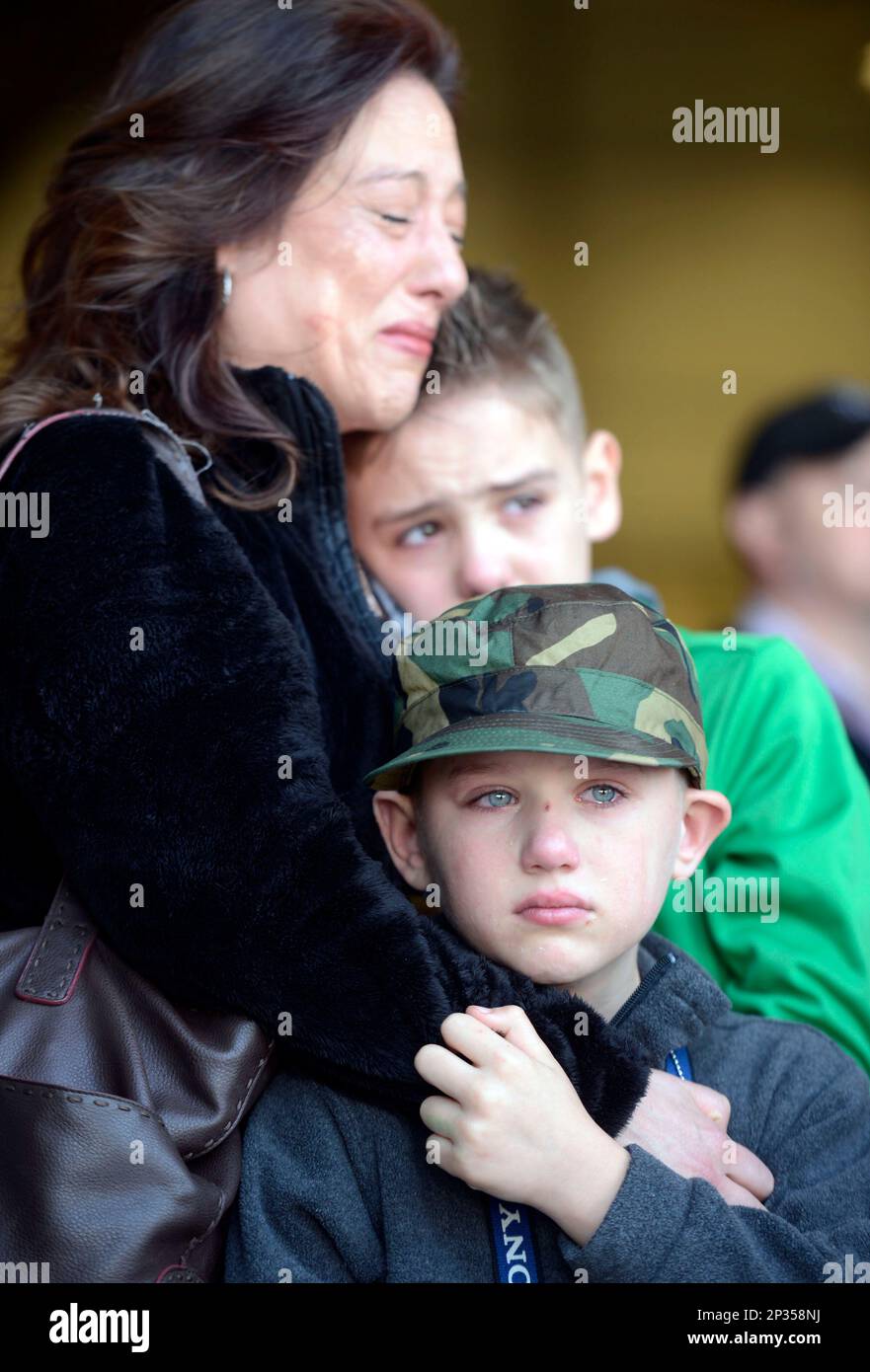 Lisa Wotring, holds her sons Luke, 8, and Max, 11, as they watch Sgt ...
