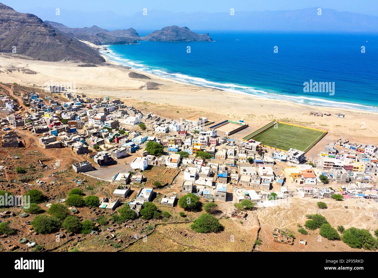 Picturesque small fishing village of Salamansa with big green football ...
