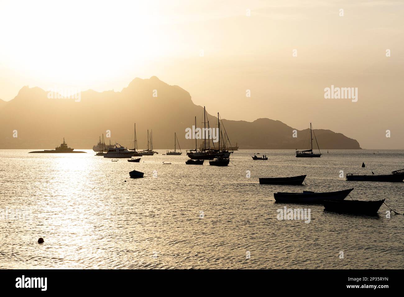 Calm Mindelo harbour with sailing and fishing boats at sunsetm Sao ...
