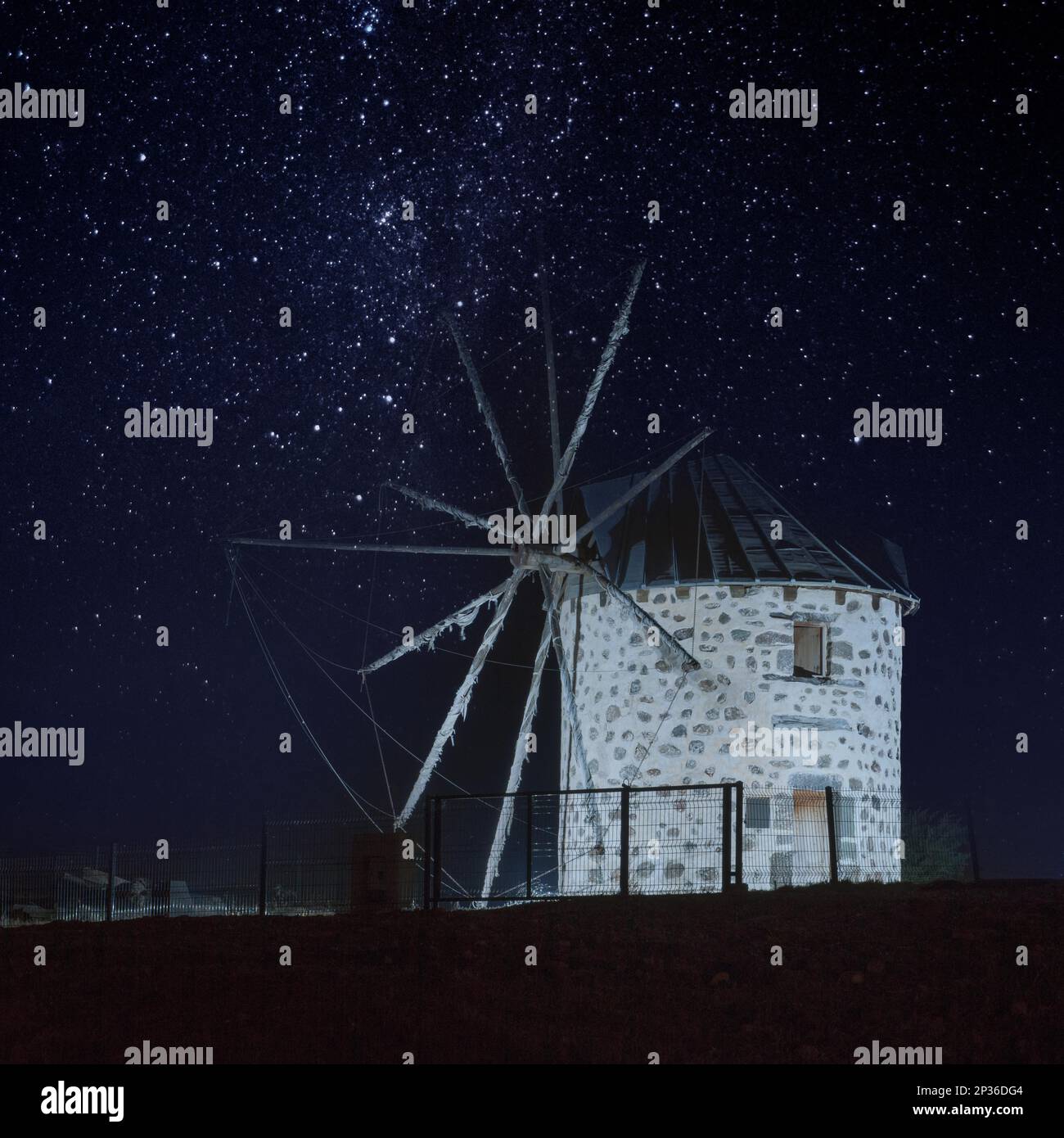 Night shot of historical windmill near Bodrum, in the background starry ...