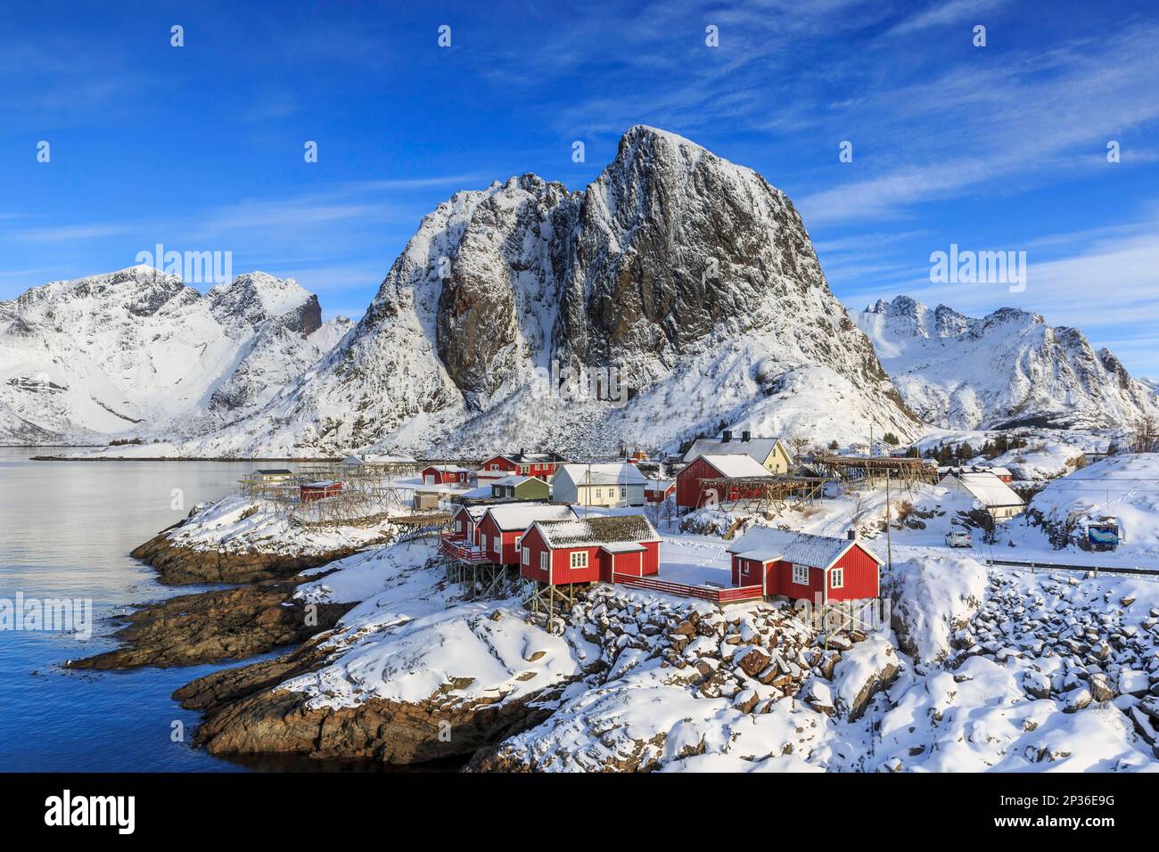 Red rorbuer in winter, fishermens cabins, snow-covered mountain ...
