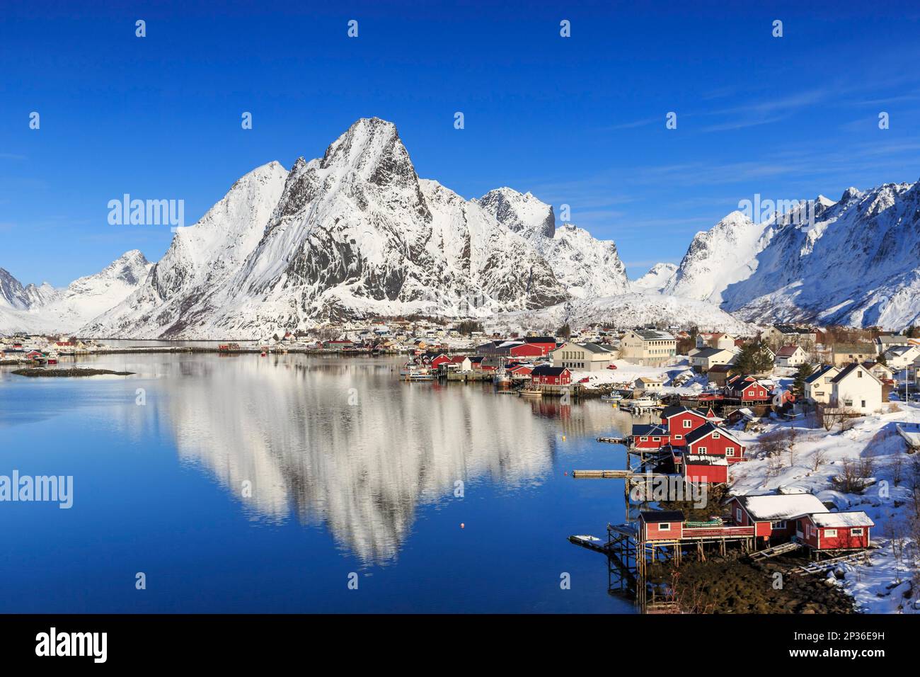 Village view Reine, winter, in the back snow-covered mountain Olstinden ...