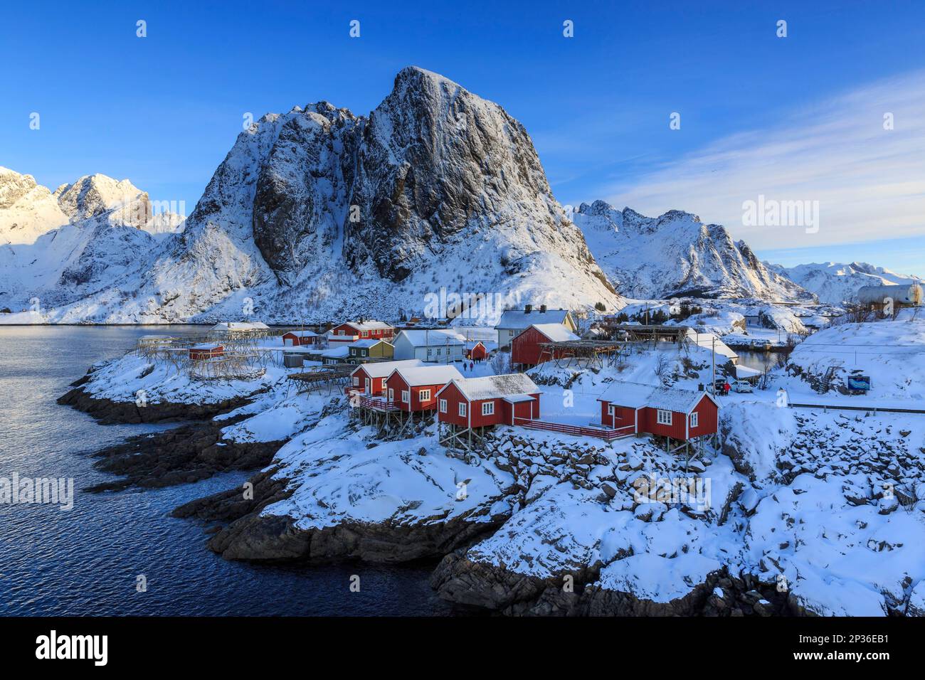 Red rorbuer in winter, fishermens cabins, snow-covered mountain ...